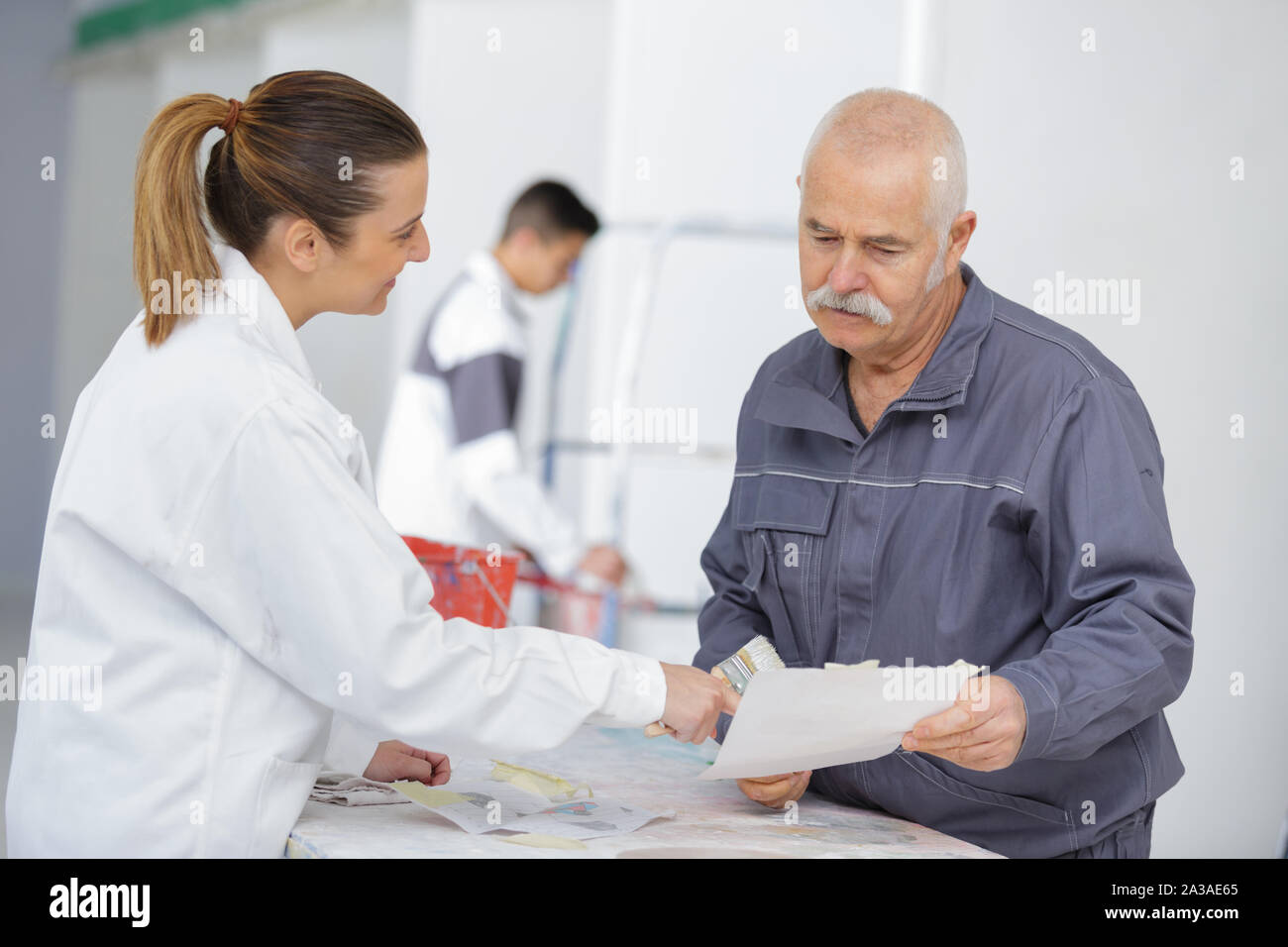 senior worker and female colleague examining something Stock Photo - Alamy
