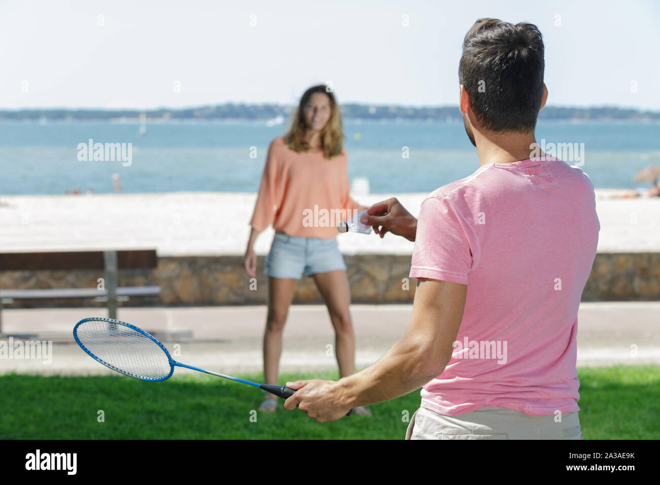 happy friends playing badminton at summer garden Stock Photo - Alamy