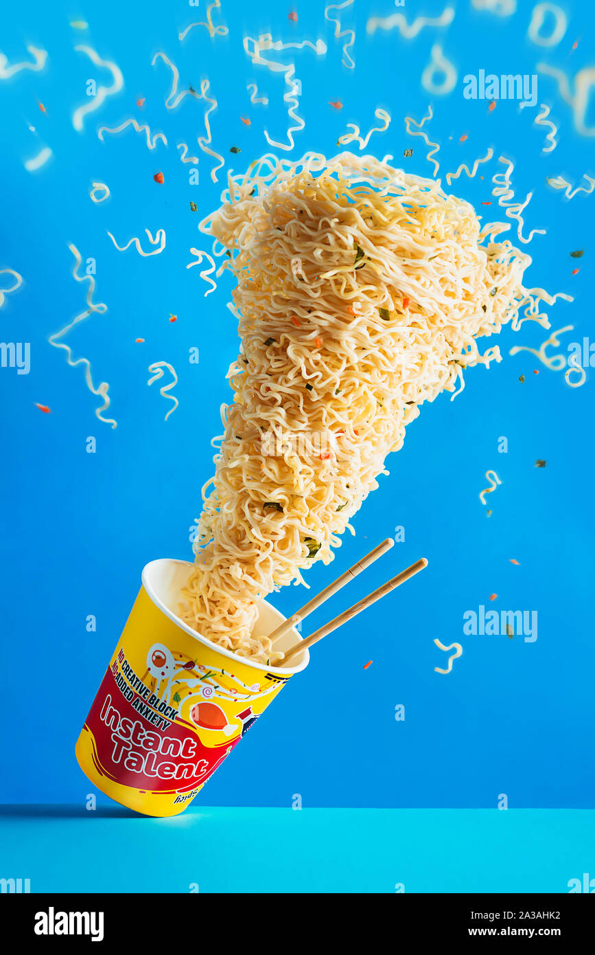 Noodle tornado in Instant Talent paper cup. Inspiration concept with ...
