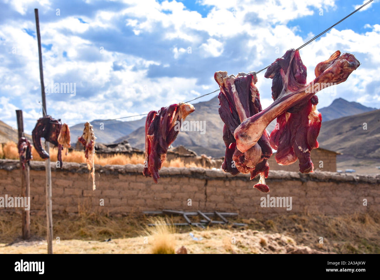 Alpaca meat and bones hang to dry on a washing line in rural Cusco ...