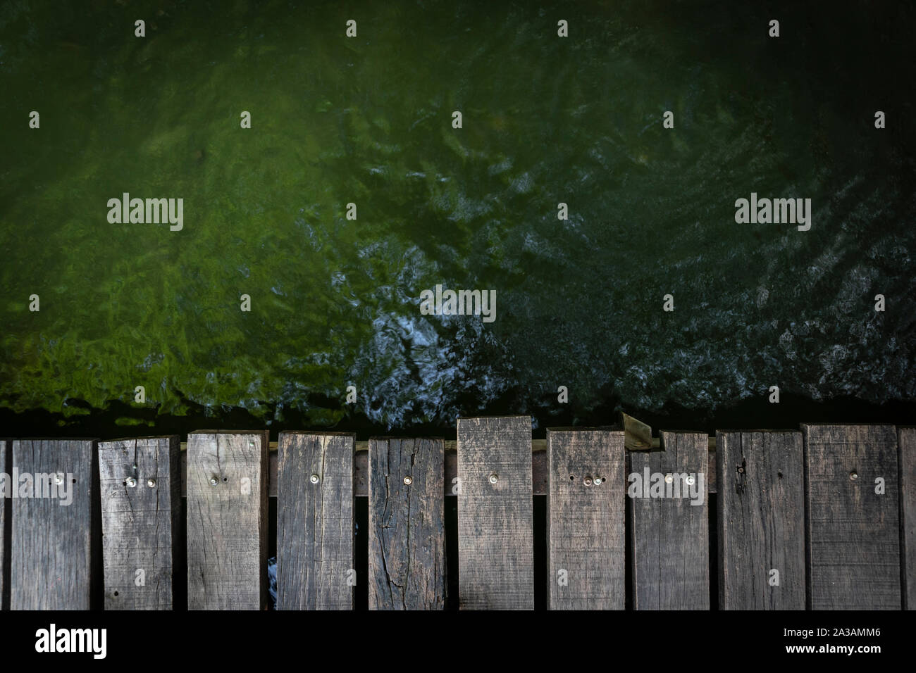 vintage wooden bridge on the water free space for text. Top view of old ...