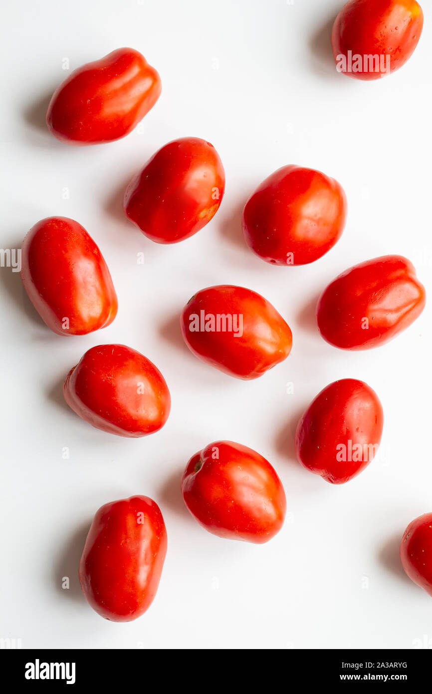 A few tomatoes closeup on white background Stock Photo - Alamy