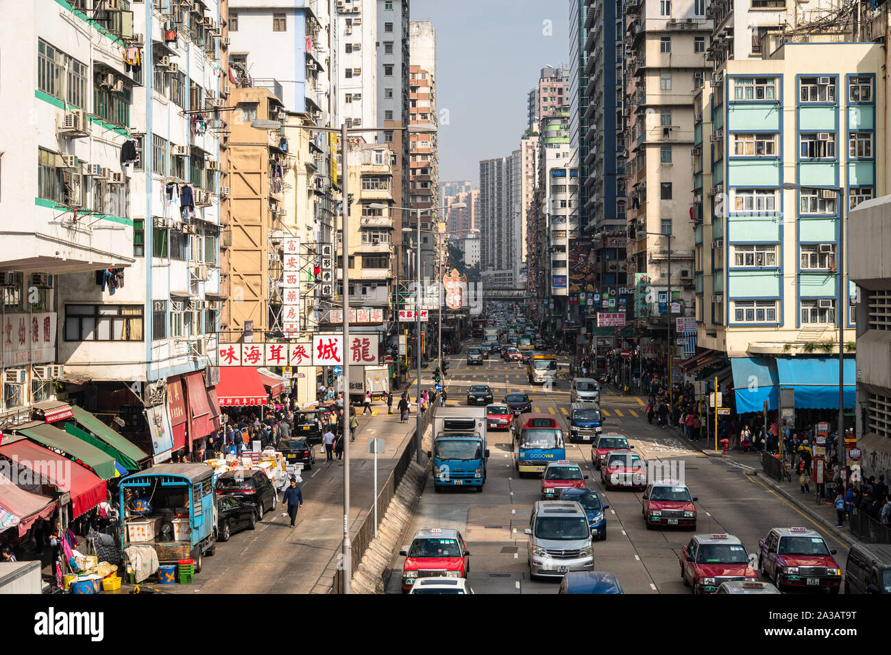 Hong Kong, China - January 27 2019: Cars and buses drive along a street ...