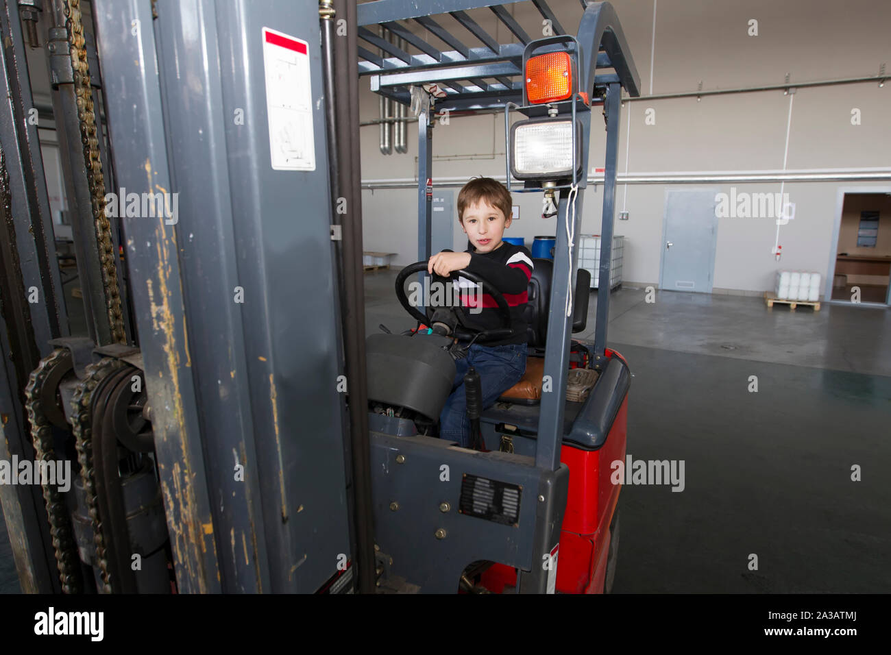 The child controls the loader. Child labour Stock Photo - Alamy