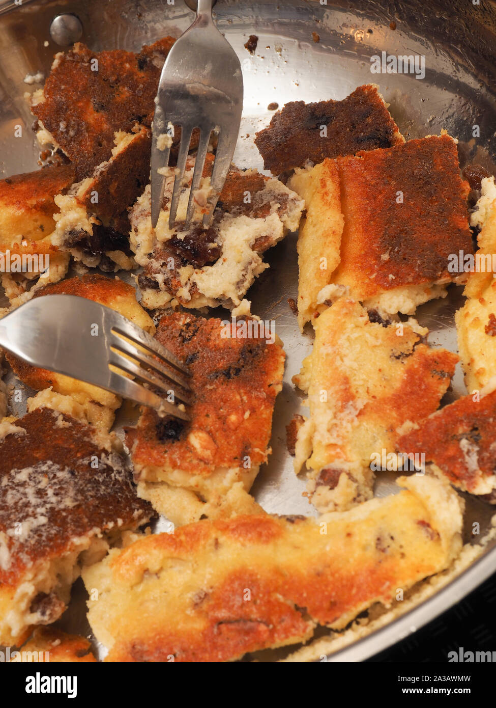 Sweet Austrian dessert, Kaiserschmarrn in a steel pan, close up shot ...
