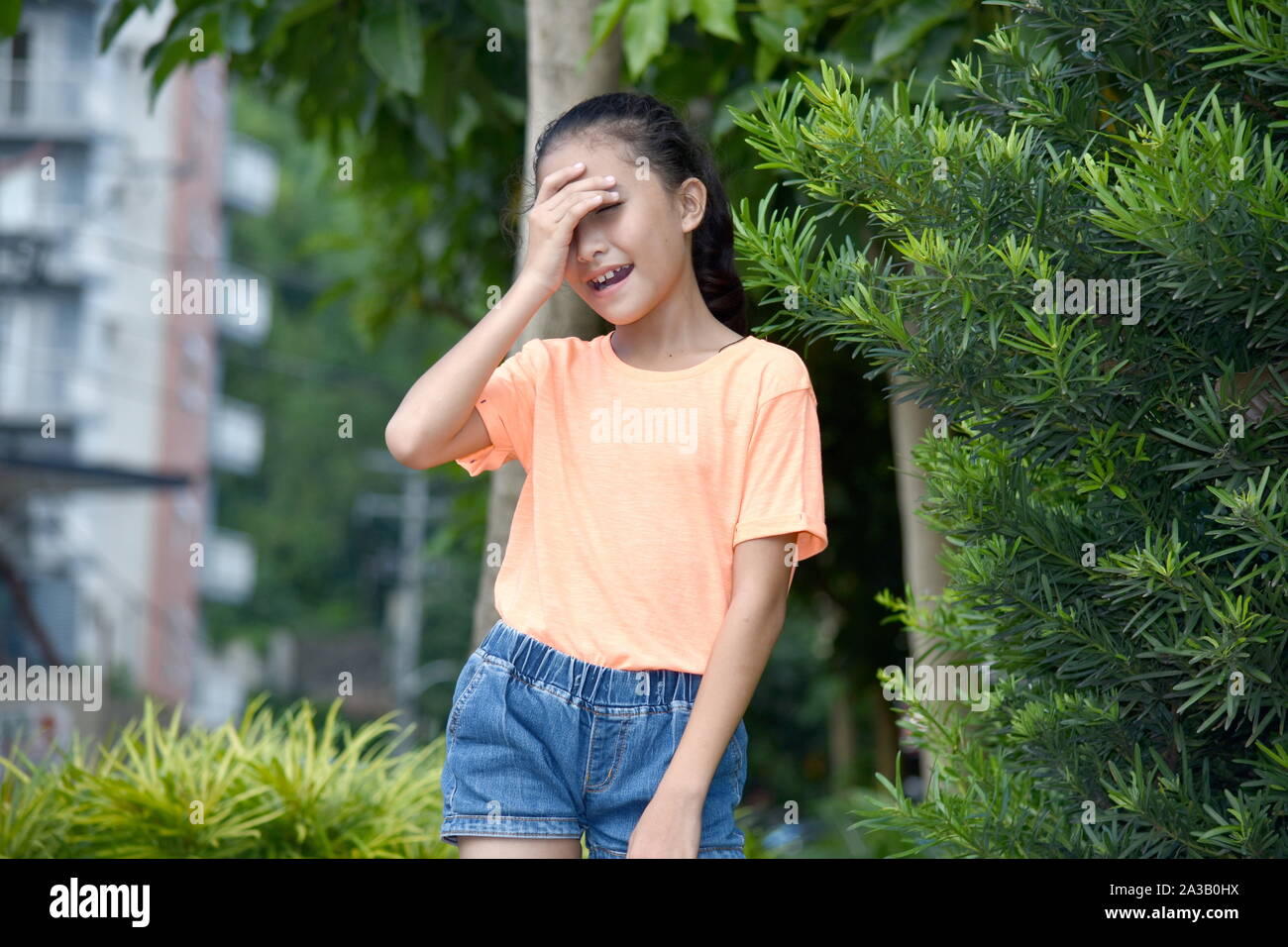 A Young Girl And Shyness Stock Photo - Alamy