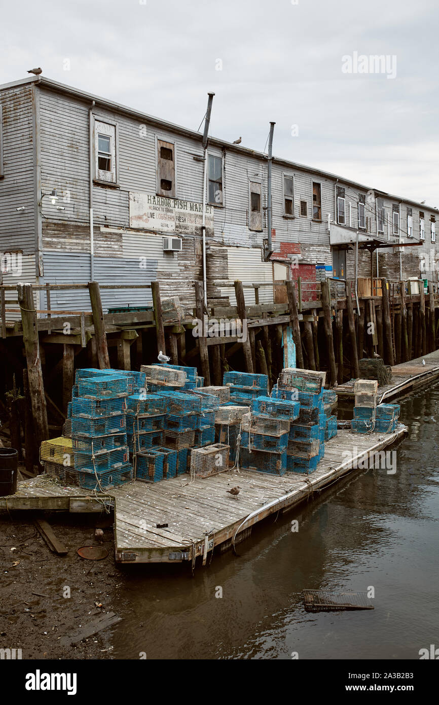 Commercial fishing wharf with stacks of lobster traps in the Old Port ...