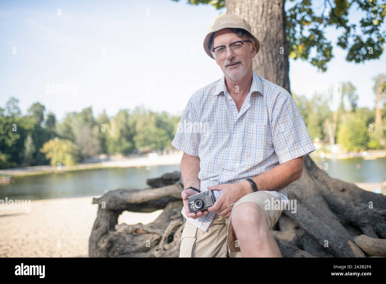 Sitting near tree hi-res stock photography and images - Alamy