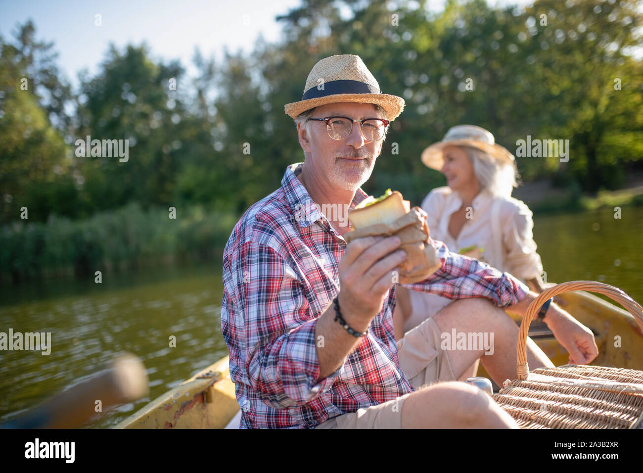 Man eating healthy sandwich while having boat trip with wife Stock ...