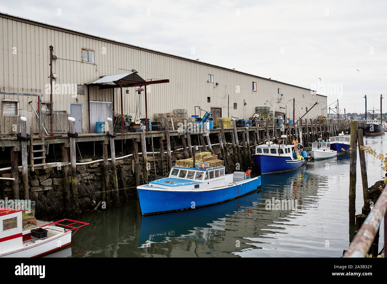 Commercial fishing wharf with stacks of lobster traps in the Old Port ...