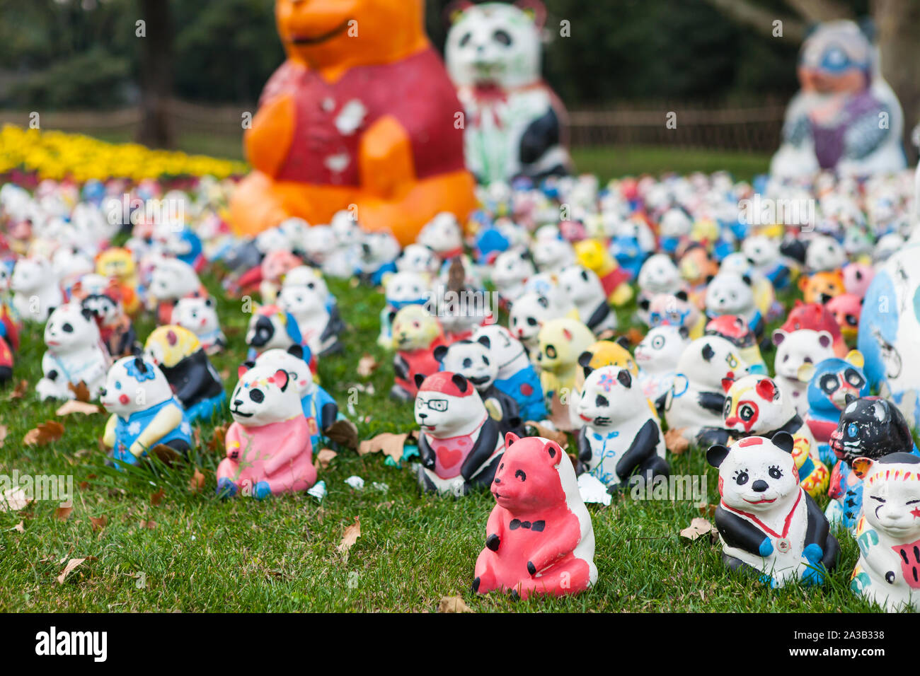 Several miniature art display of hand drawn pandas are placed on the ...