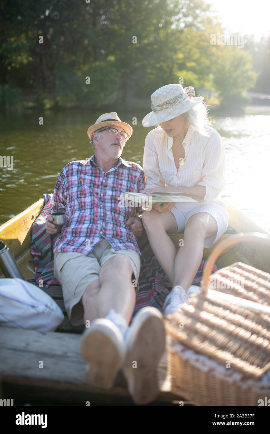 Couple chilling in boat and reading book at the weekend Stock Photo - Alamy