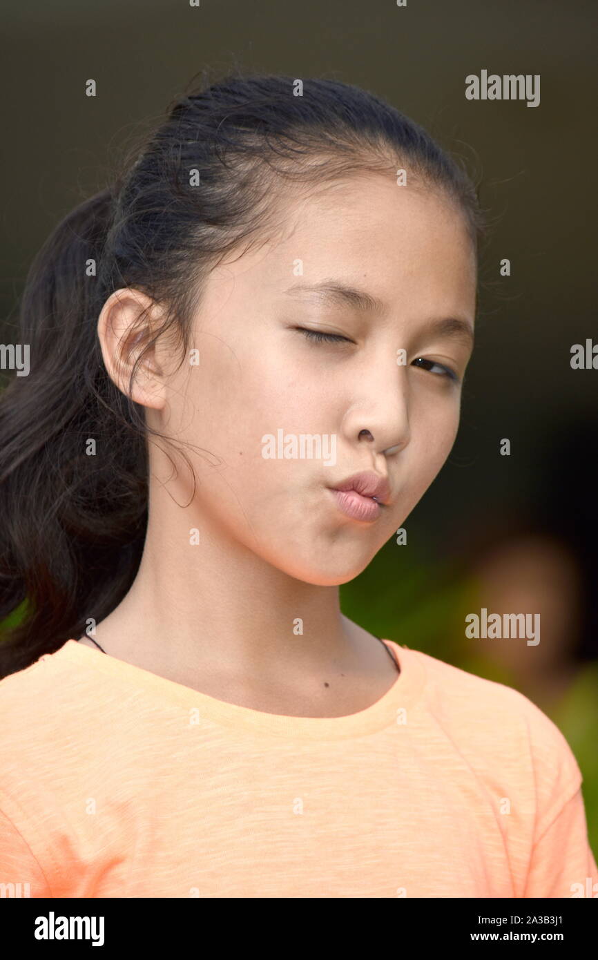 A Winking Beautiful Diverse Girl Stock Photo - Alamy