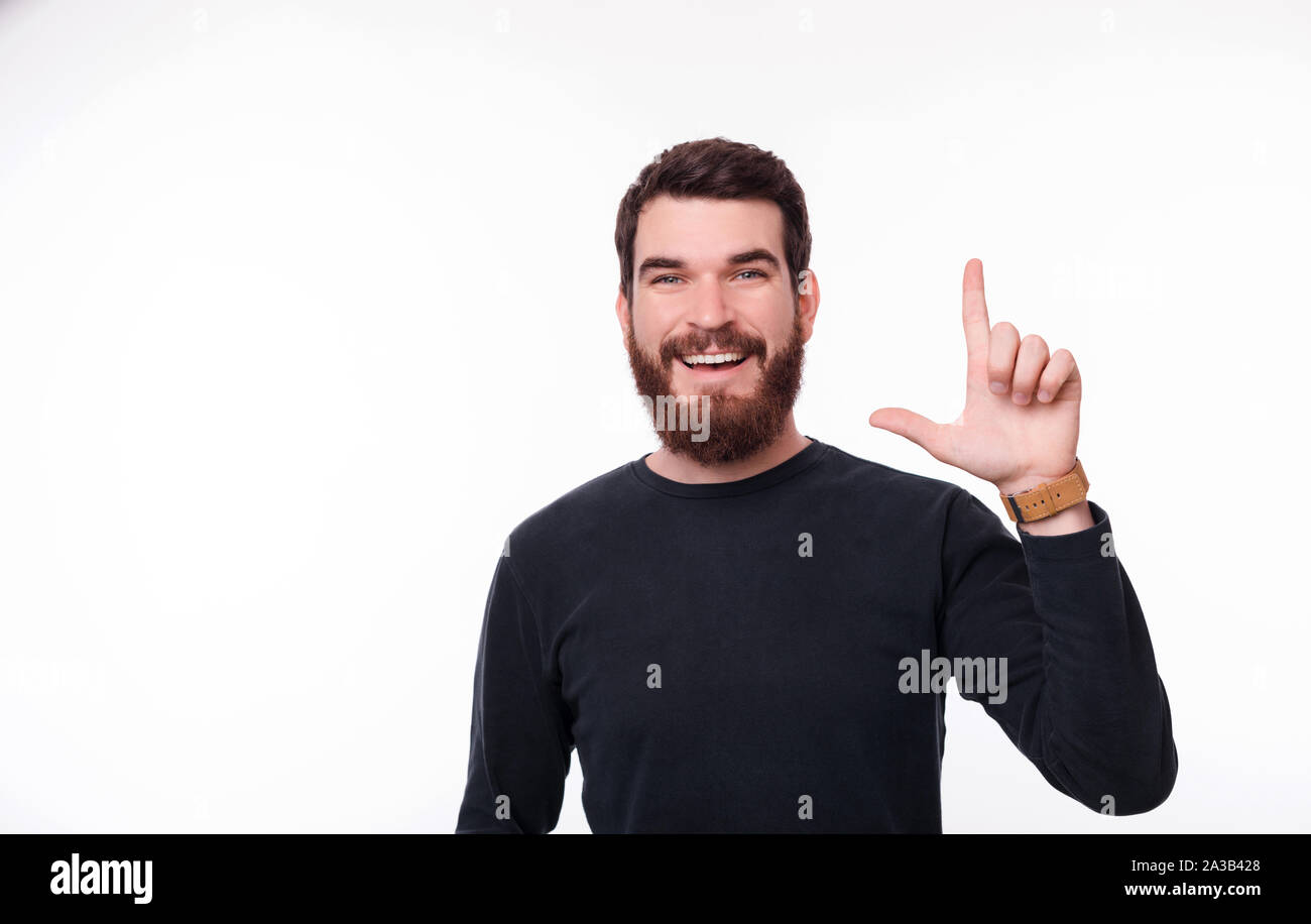 Young man is pointing upwards on white background Stock Photo - Alamy