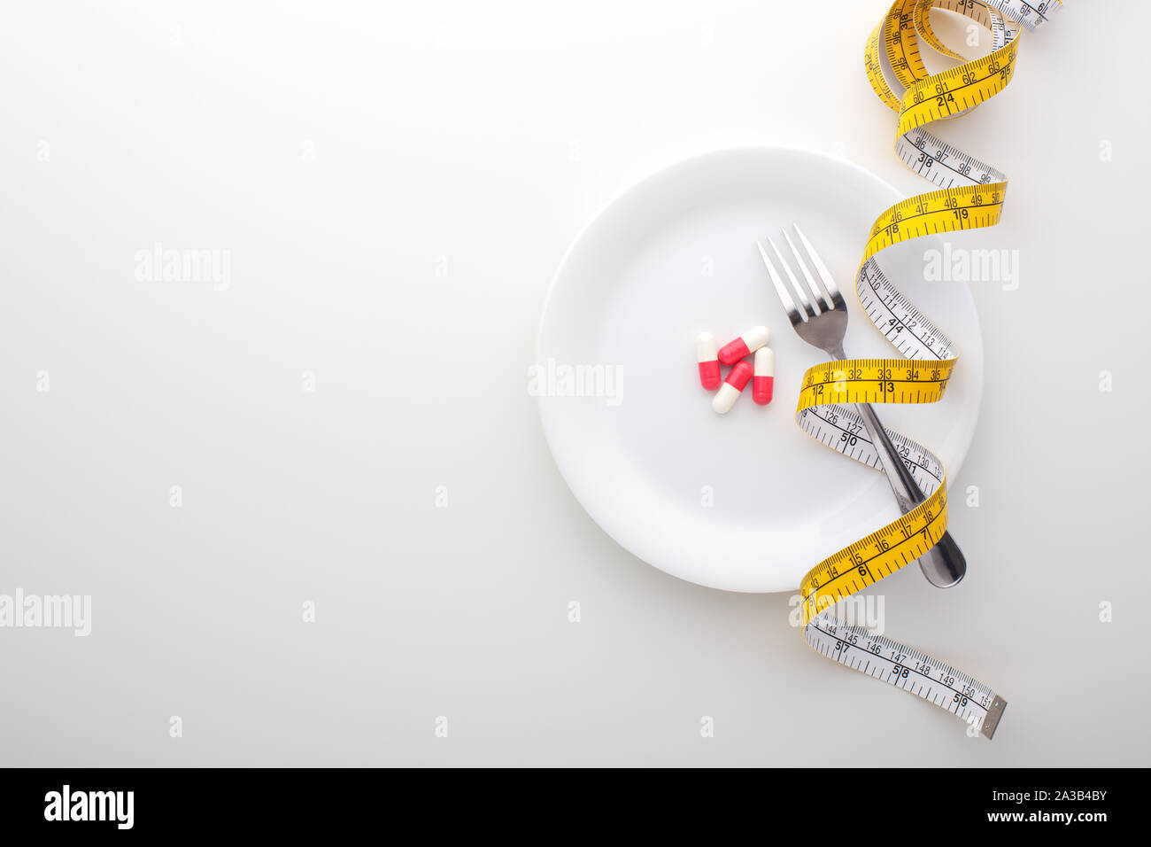 Diet, weight loss background with pills, supplement on plate and ...