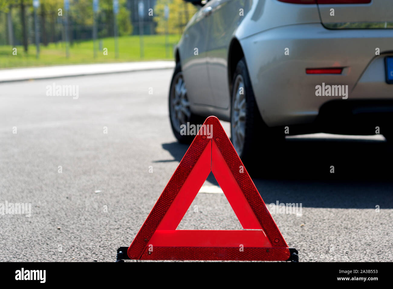 A warning triangle and broken car Stock Photo - Alamy