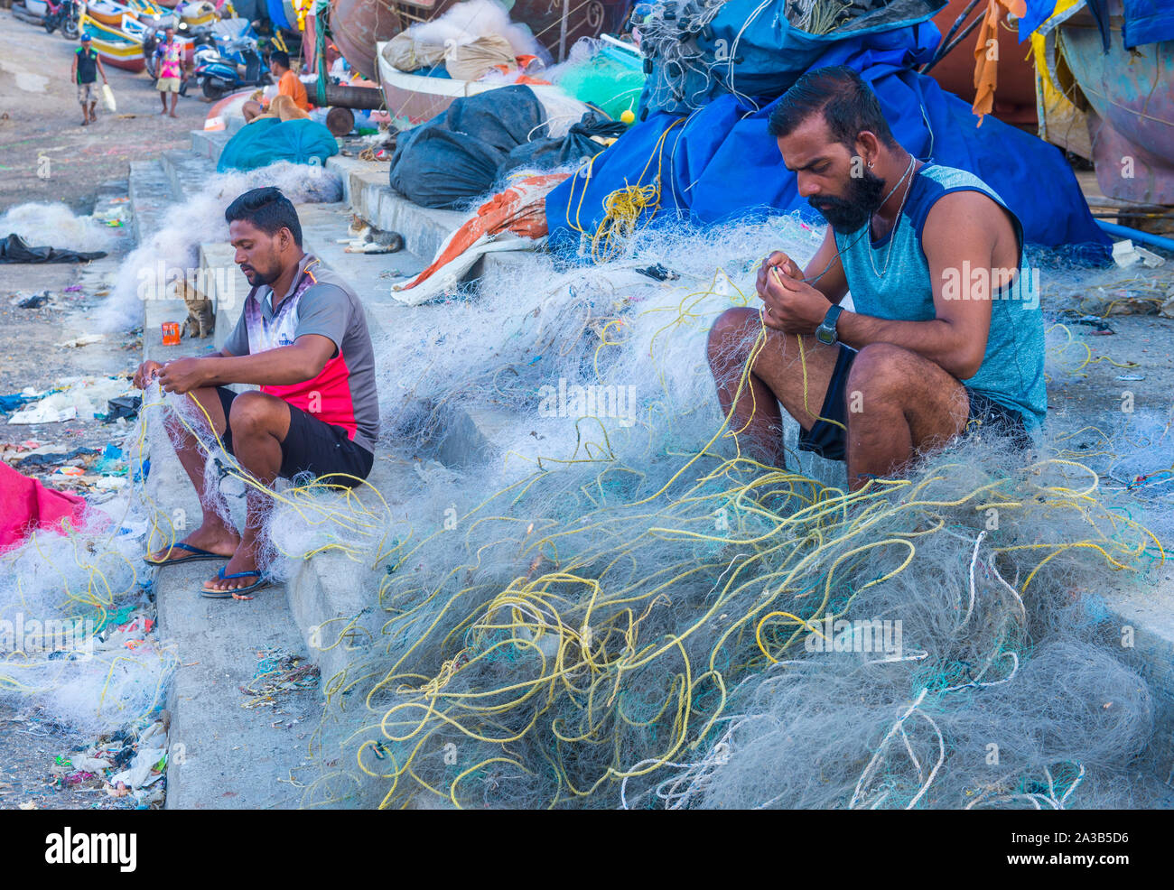 Indian men working in a fishermen village near Mumbai India Stock Photo ...