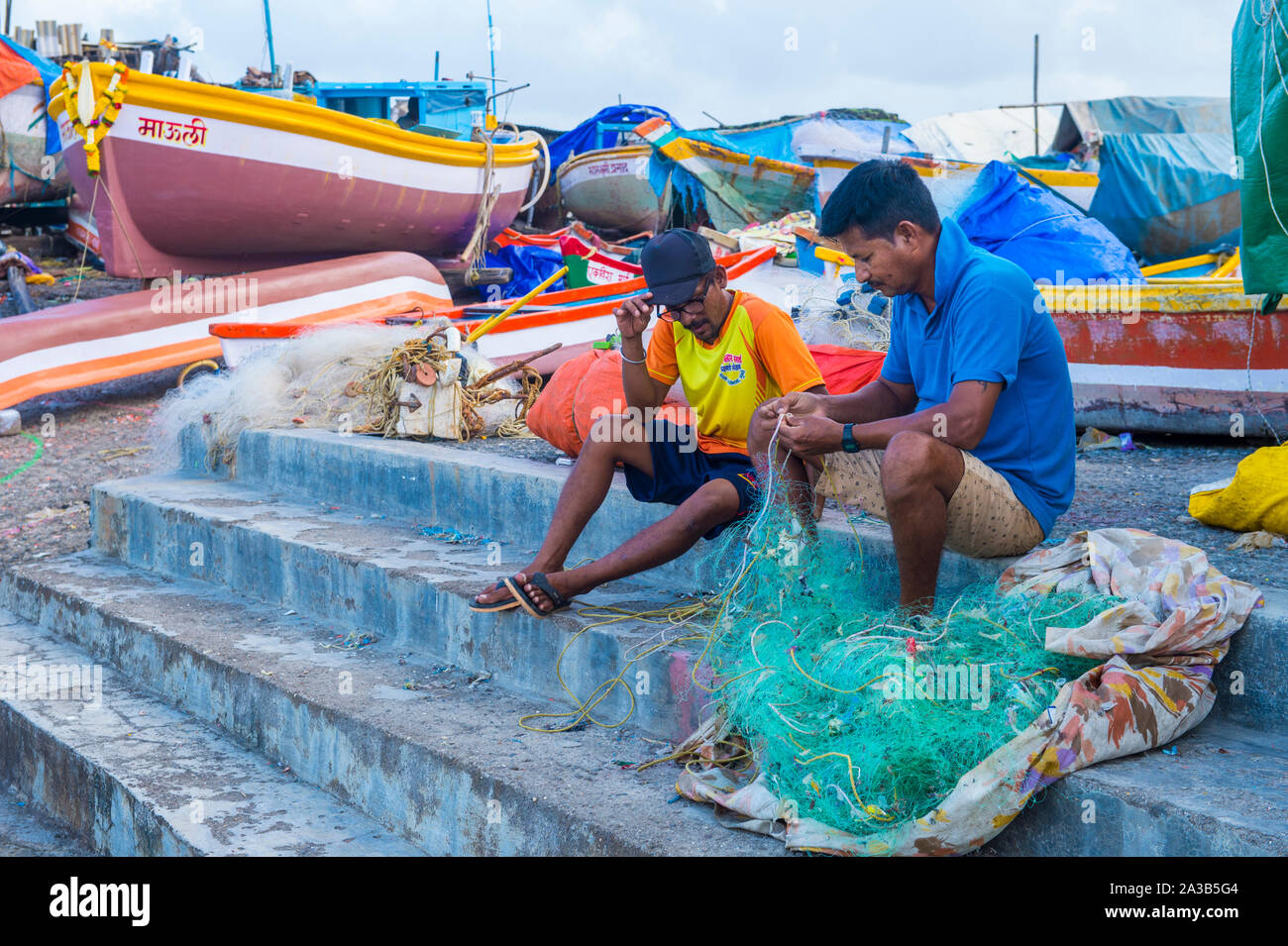 Indian men working in a fishermen village near Mumbai India Stock Photo ...