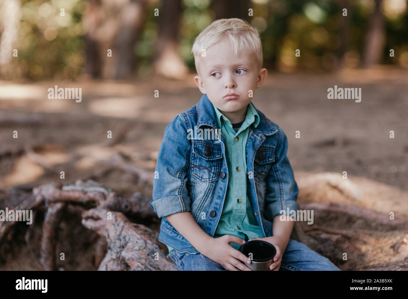 little boy holding a cup of tea outdoors. child drinks tea Stock Photo ...