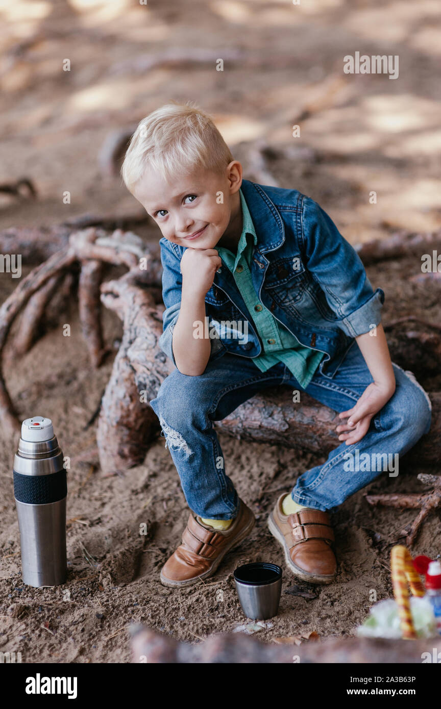little boy holding a cup of tea outdoors. child drinks tea Stock Photo ...