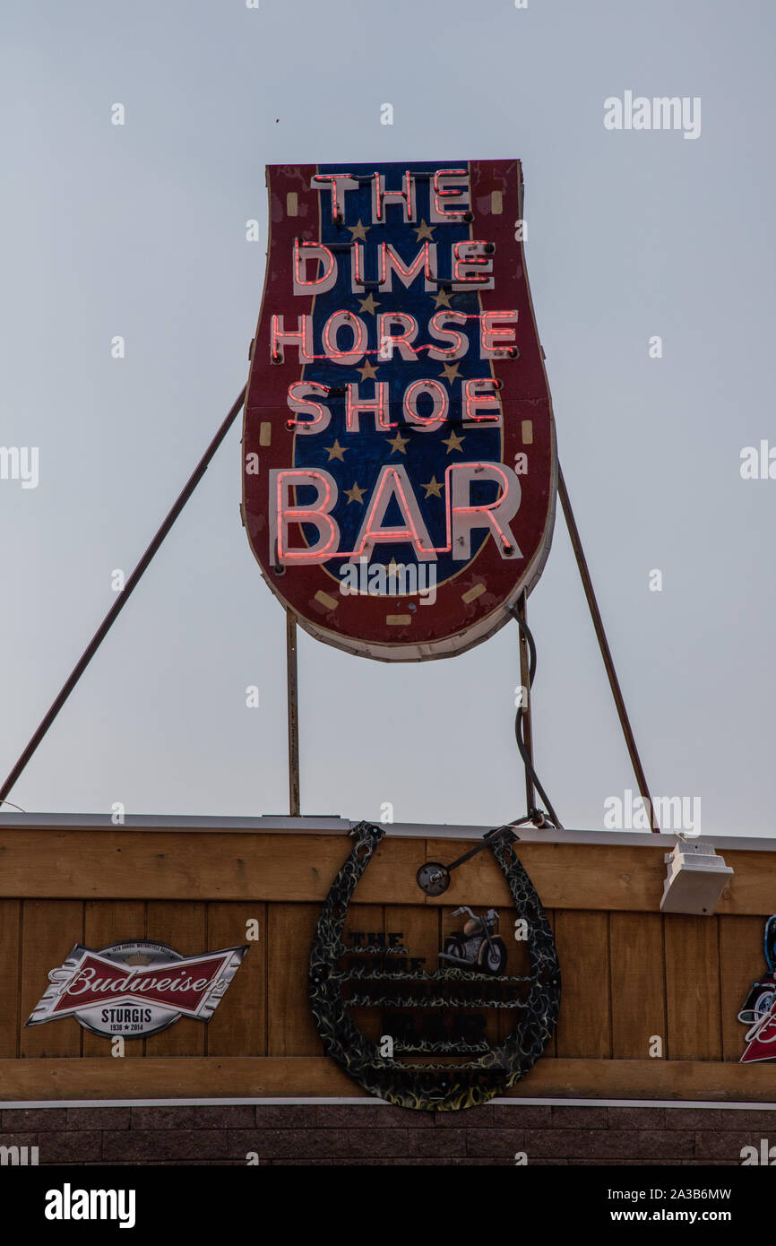 Sign for the Dime Horseshoe Bar, a popular biker bar, welcoming passing ...