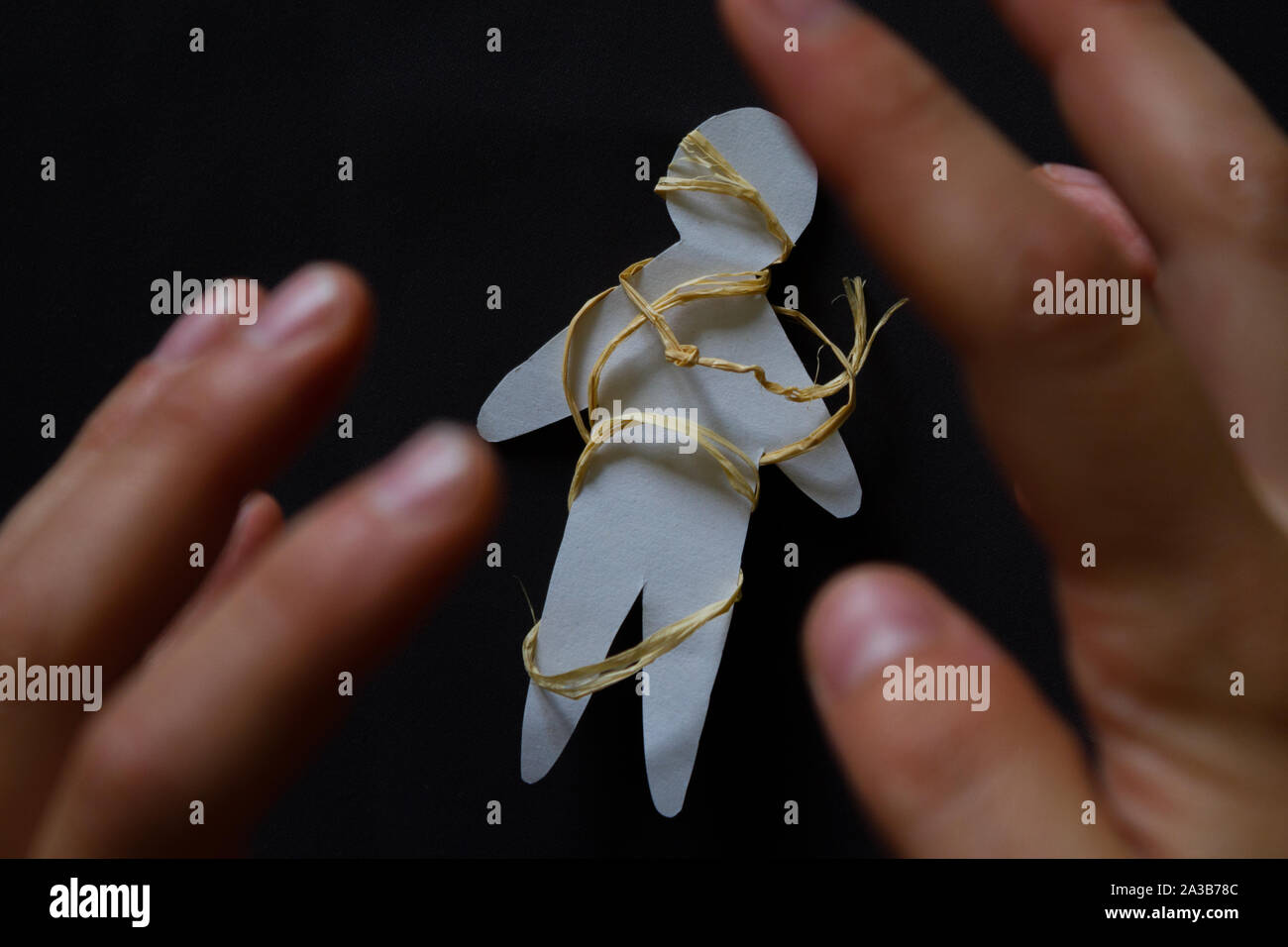 Voodoo doll. Ropped person on dark background Stock Photo - Alamy