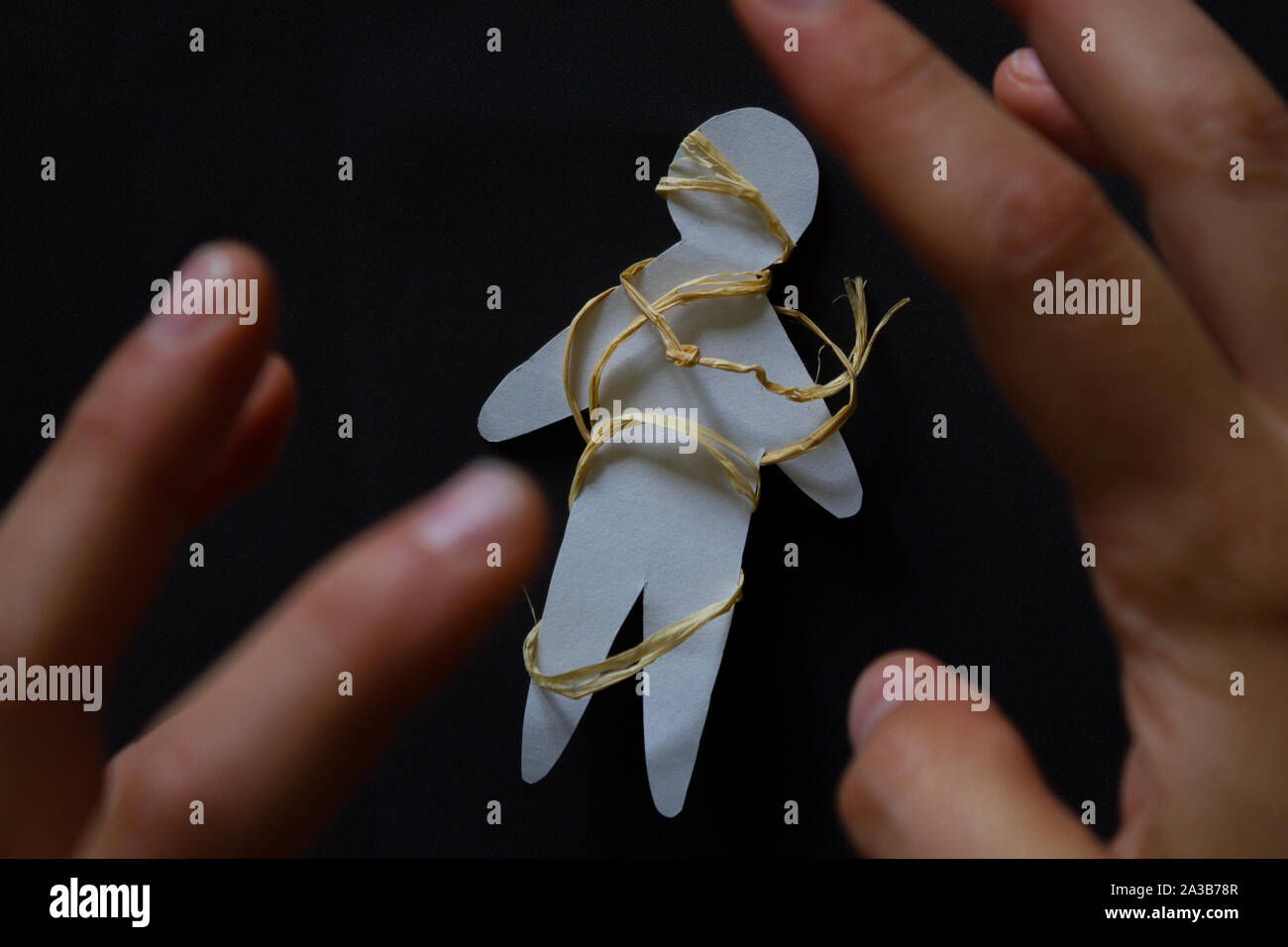 Voodoo doll. Ropped person on dark background Stock Photo - Alamy