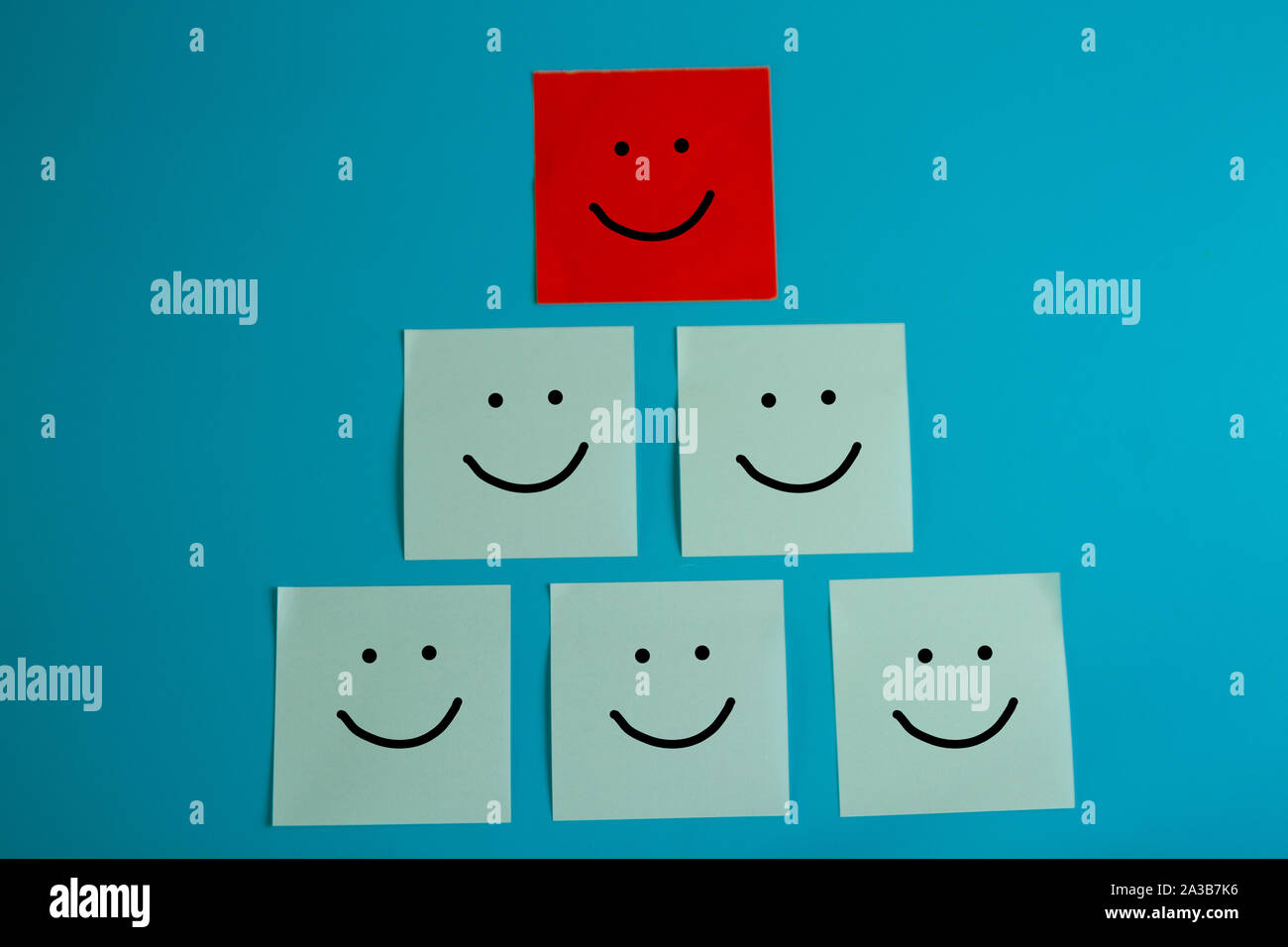 Pyramid of happy smileys. Good company management Stock Photo - Alamy