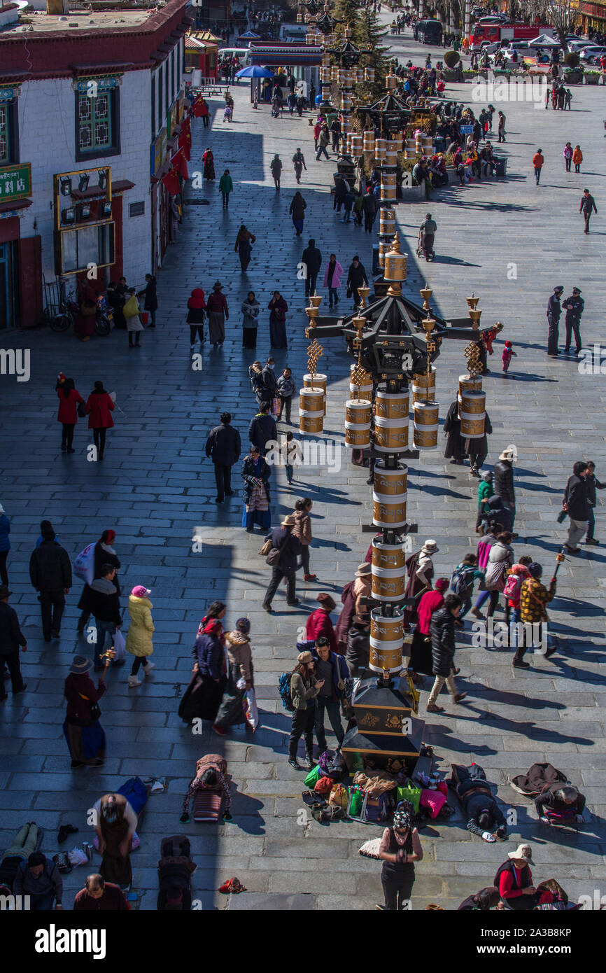 Tibetan pilgrims circumambulate around and prostrate themselves in ...