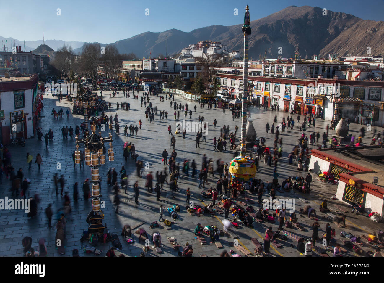 Tibetan pilgrims circumambulate around and prostrate themselves in ...