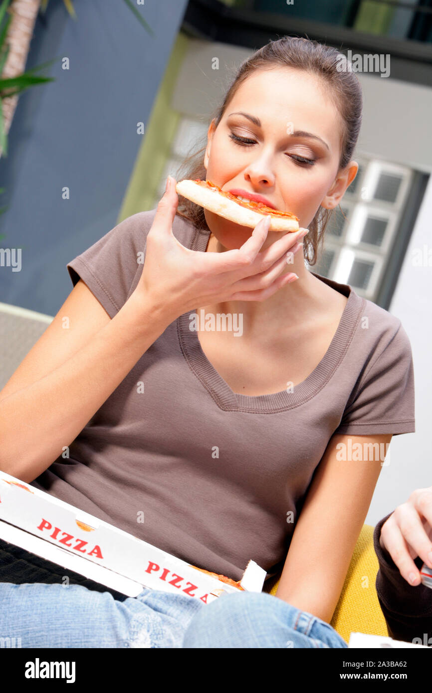 Biting into a slice of pizza hi-res stock photography and images - Alamy