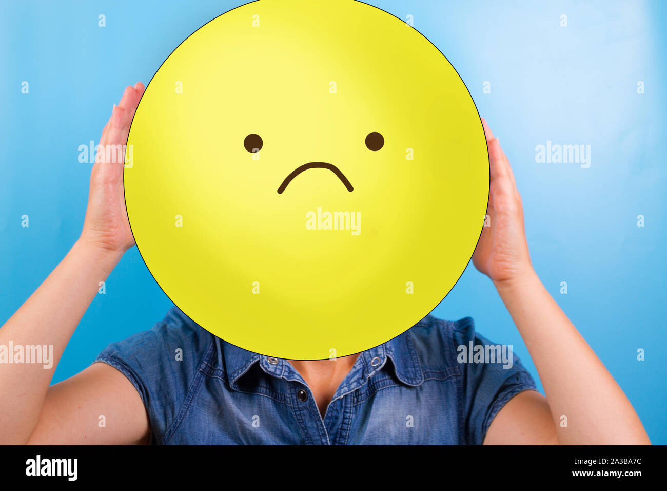 Unrecognizable woman with sad smiley instead of face Stock Photo - Alamy