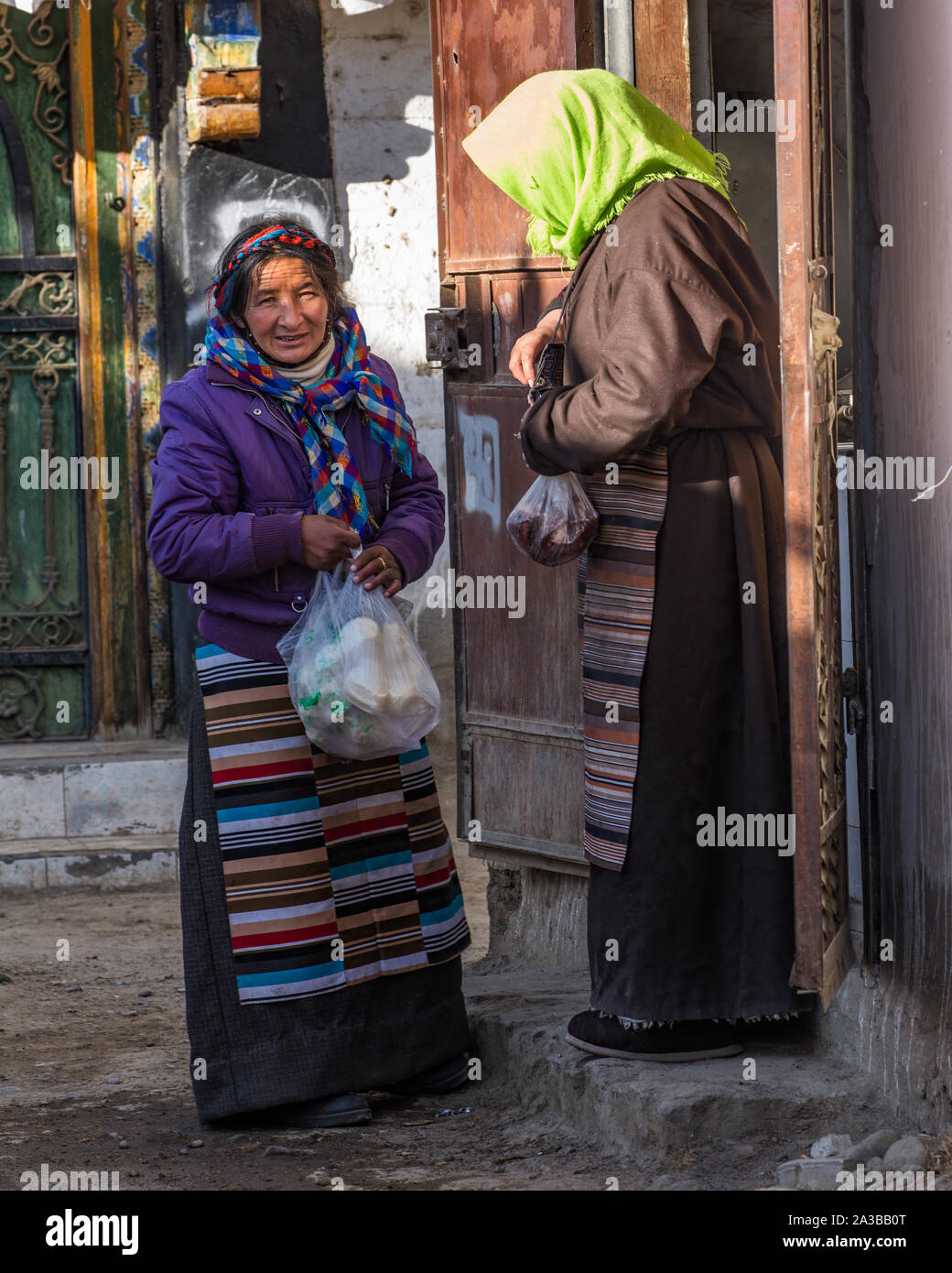 Two Tibetan women wearing their traditional bangdian or pangden aprons ...