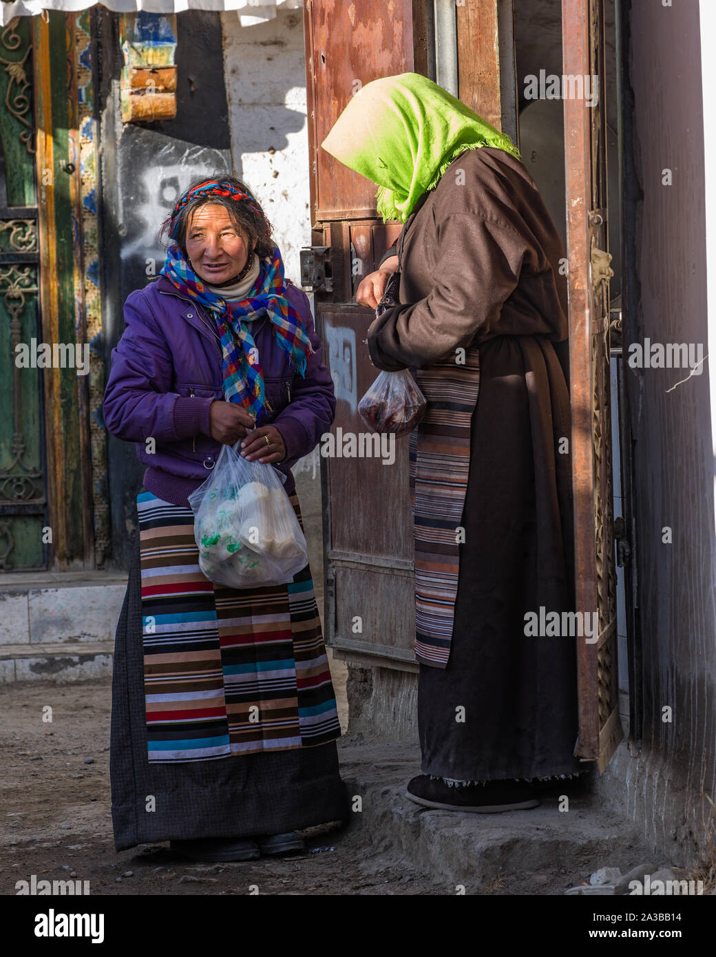 Two Tibetan women wearing their traditional bangdian or pangden aprons ...