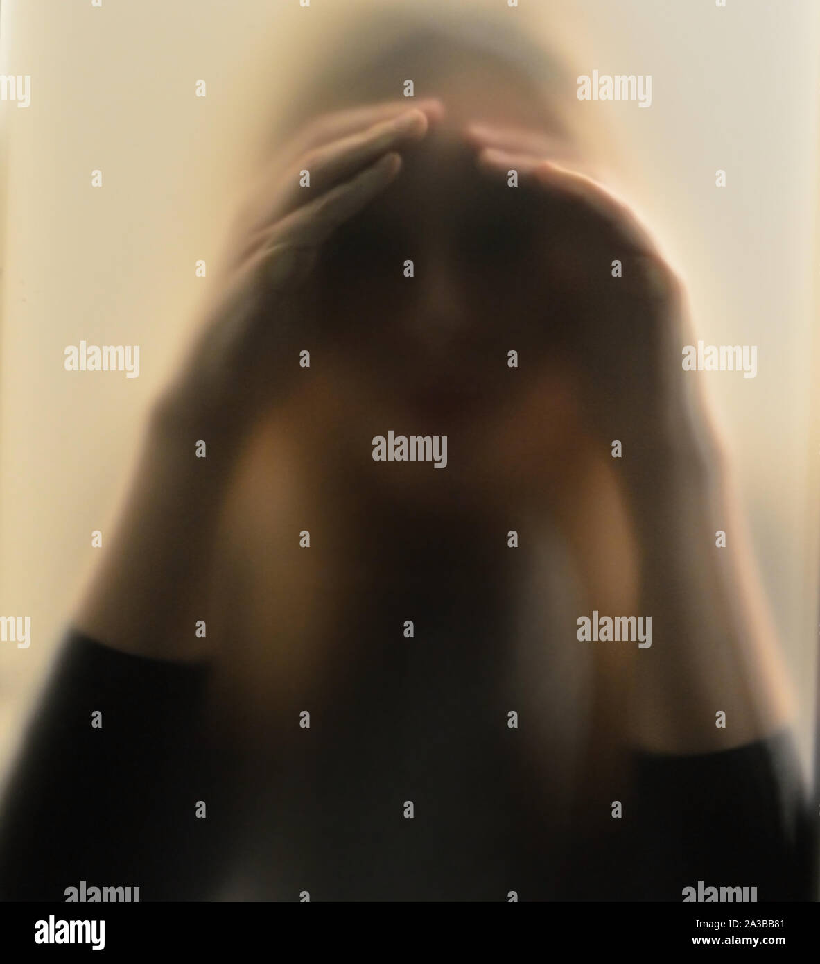 Girl looking behind frosted glass Stock Photo - Alamy