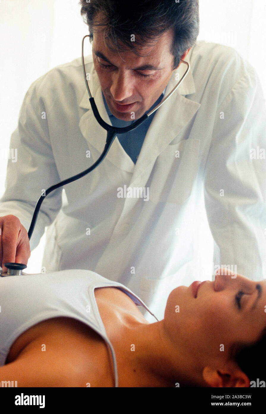 doctor examining a patient Stock Photo - Alamy