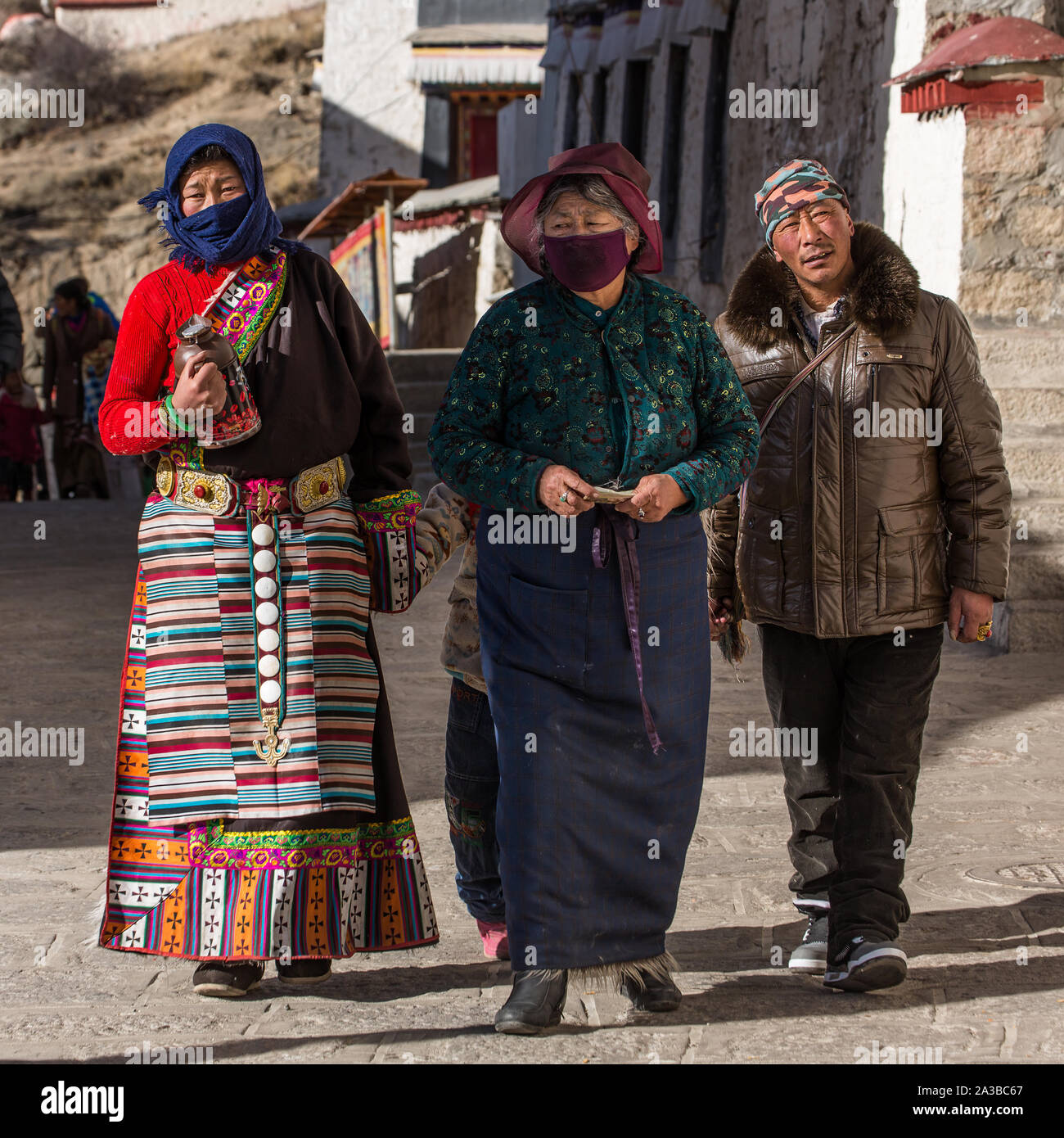 Buddhist pilgrims, a man and two women from the Kham region of eastern ...