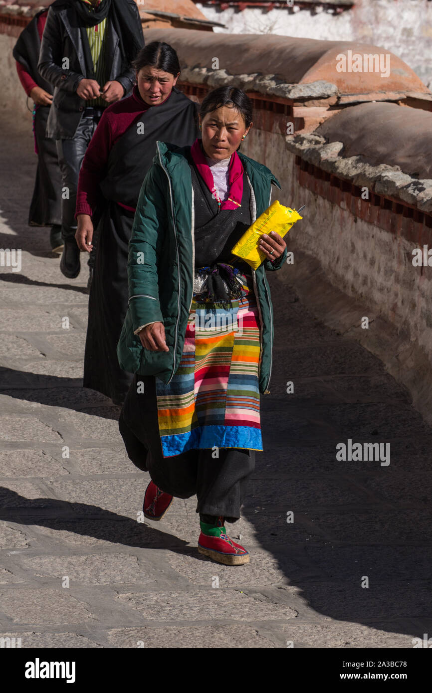 A Tibetan woman pilgrim in traditional dress, including her bangdian or ...