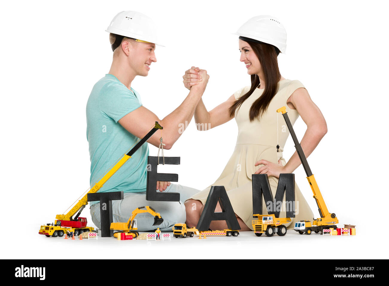 Forming a team: Joyful man and woman building team-word Stock Photo - Alamy