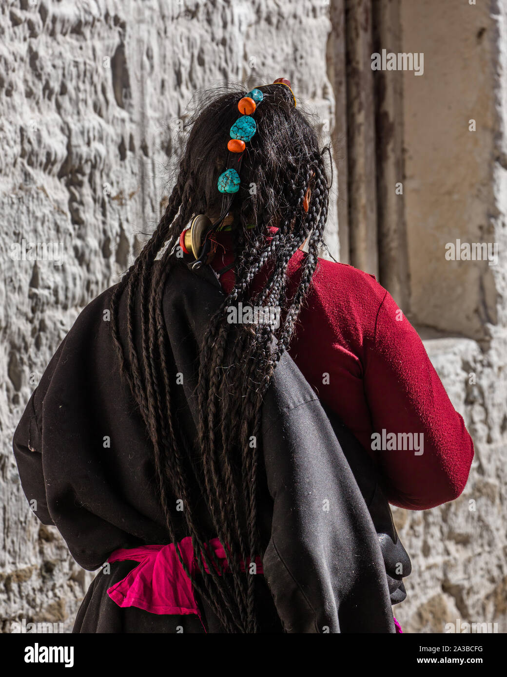 A Khamba Tibetan pilgrim from the Kham region of Tibet with her hair in ...