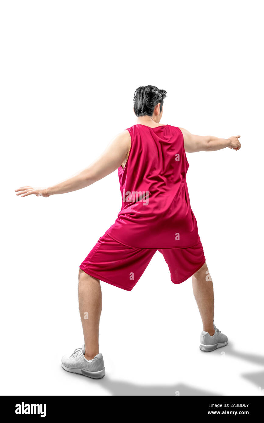 Rear view of Asian man basketball player in the pose of dribbling the ...