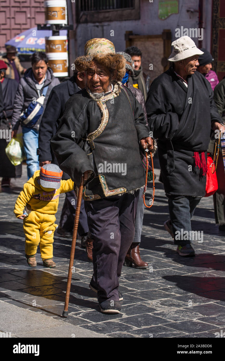 A Tibetan Buddhist pilgrim in a golden thread hat from the Kham region ...