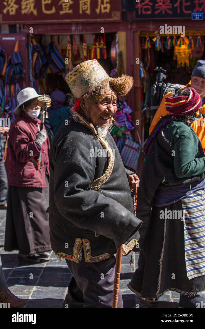 A Tibetan Buddhist pilgrim in a golden thread hat from the Kham region ...