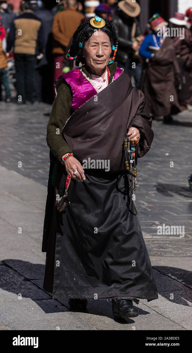 A Khamba Tibetan woman from the Kham region of eastern Tibet with her ...
