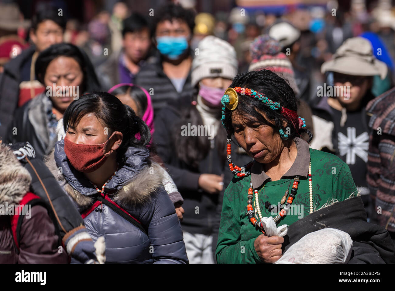 Tibetan pilgrims circumambulating the kora around the Jokhang Temple in ...
