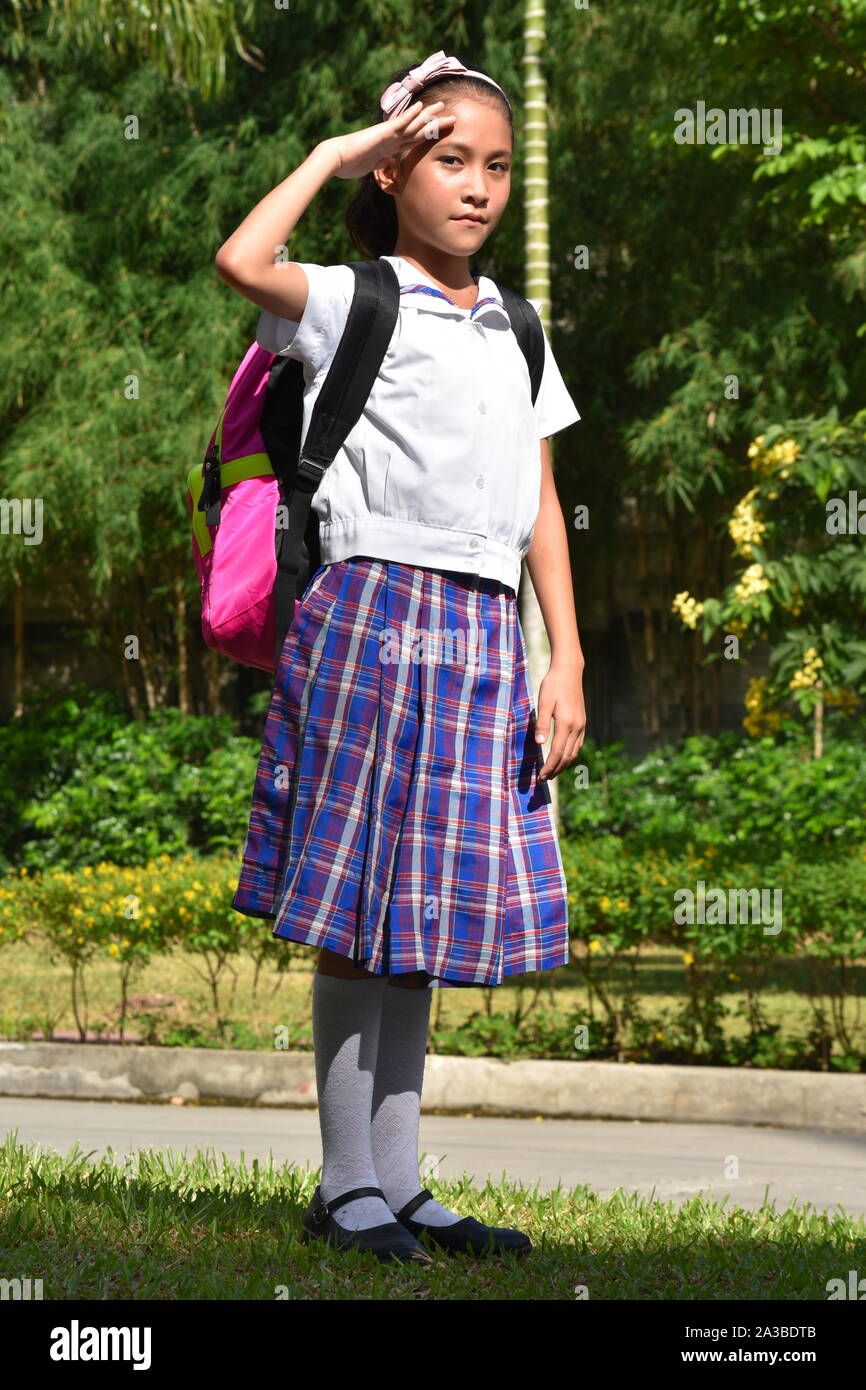 A Girl Student Saluting With Notebooks Stock Photo - Alamy