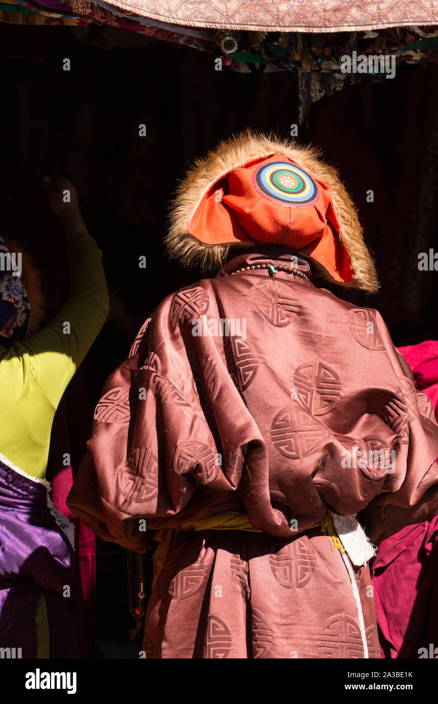 A Tibetan woman in a silk hat lined with red fox fur called a Lhakkya ...