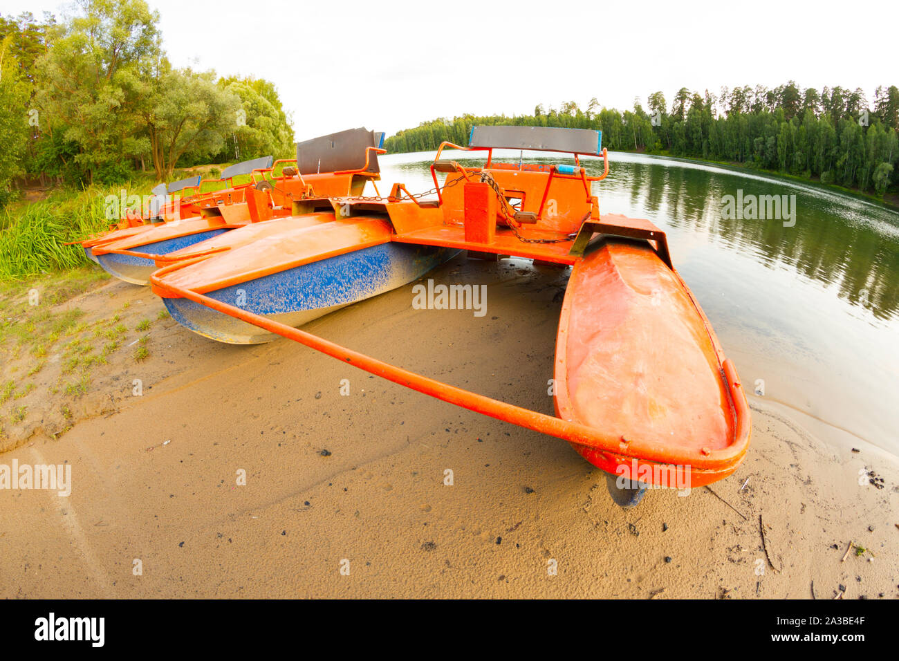 Old orange catamaran on lake. Hipster lifestyle Stock Photo - Alamy