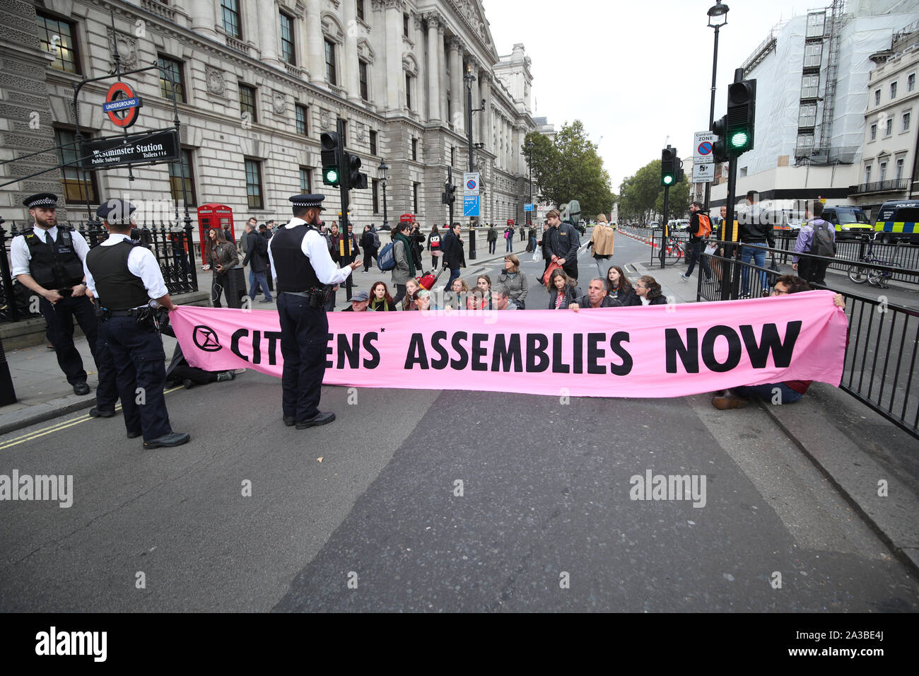 Protesters from Extinction Rebellion (XR) block a road in Westminster ...