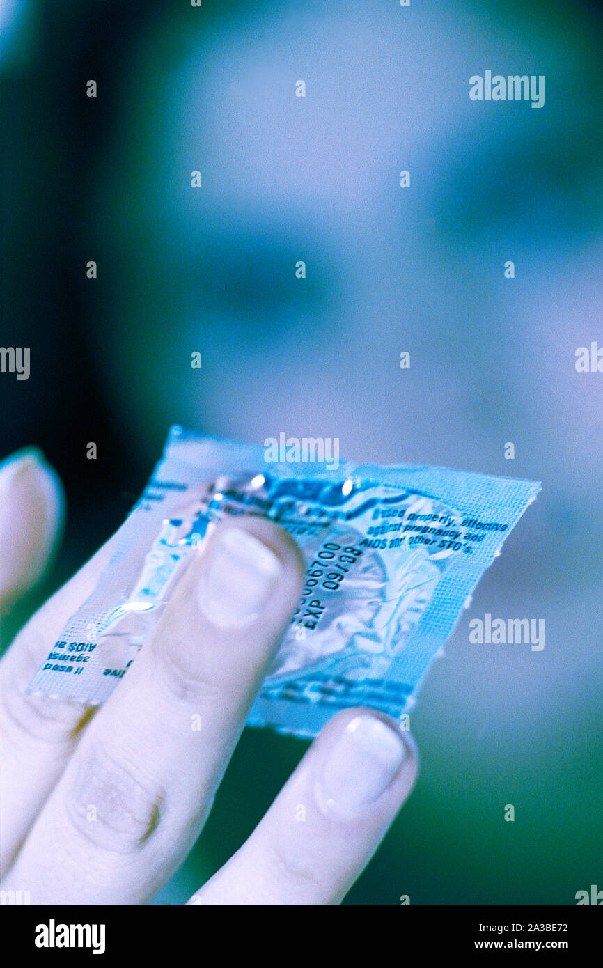 Woman holding condom hi-res stock photography and images - Alamy